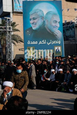 Supporters of the Popular Mobilization Forces hold a posters of Abu ...