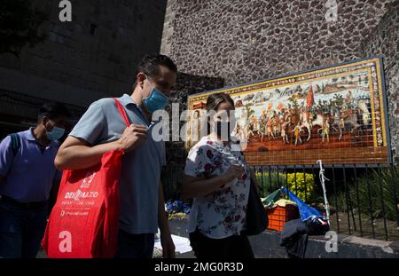 Locals walk past a mural dedicated to Spanish conquistador Hernan ...