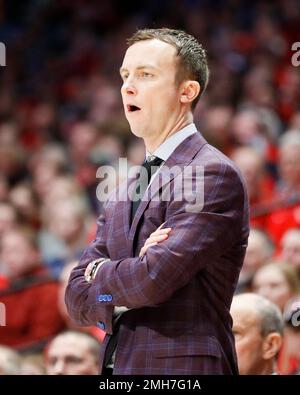 Massachusetts head coach Matt McCall, right, reacts and is held back by ...