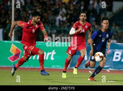 Bahrain's Sayed Redha Isa, center, battles for the ball with Cambodia's ...
