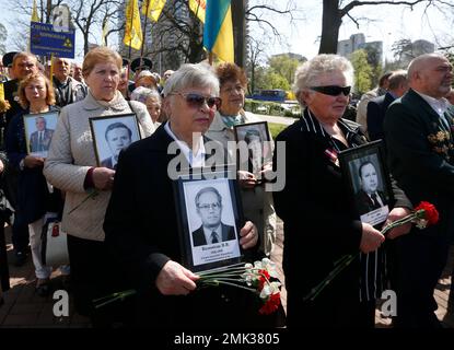 Widows of Chernobyl victims hold portraits of their husbands who died ...