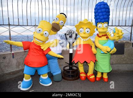 Costumed characters, from left, Bart Simpson, Homer Simpson, Lisa ...
