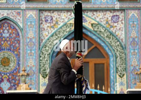 Afghans kisses a holy mace for blessings during activities marking the ...