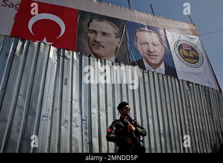 Backdropped by posters of modern Turkey's founder Mustafa Kemal Ataturk, left, and Turkey's ...