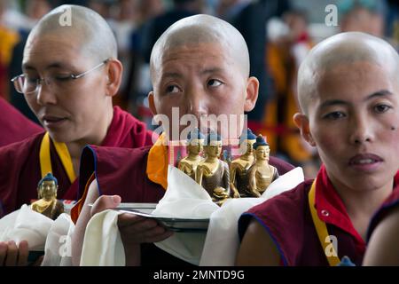 Exile Tibetans Buddhist nuns carry ceremonial offerings as they conduct ...