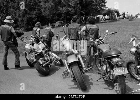 Members of the Pagans motorcycle gang wait for a priest to conclude ...