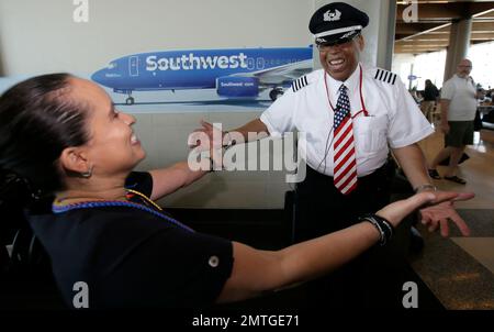 Southwest Airlines captain Louis Freeman talks on a cell phone as he ...