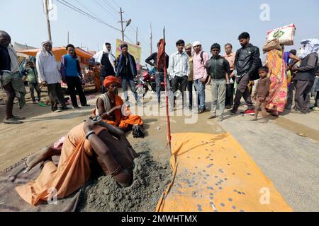 A Sadhu, or Hindu holy man Mauni Baba, offers prayers at the Sangam ...