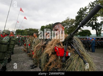 Philippine President Rodrigo Duterte checks the scope of a Chinese-made ...