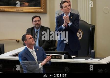 Oklahoma Gov. Kevin Stitt, left, holds hands with his wife, Sarah Stitt ...