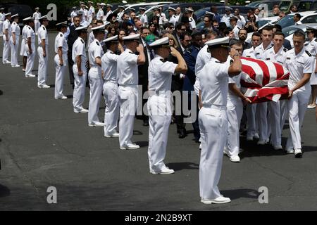 U.S. Navy midshipmen salute as the casket carrying the remains of U.S ...