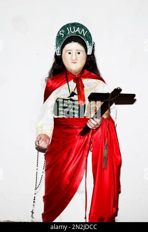 A penitent poses for a picture dressed with typical Apostle dress ...