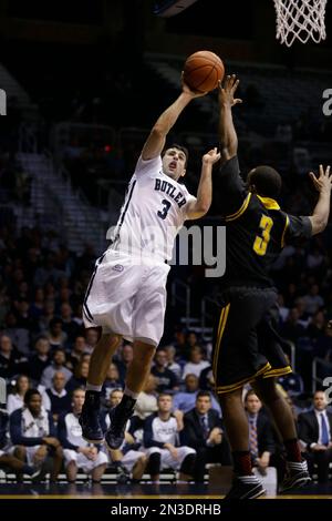 Butler guard Alex Barlow, left, heads up court after stealing the ball ...