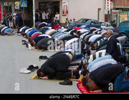 Kosovo Muslims offer Eid al-Fitr prayers outside the Sultan Mehmet Fatih grand mosque during the ...