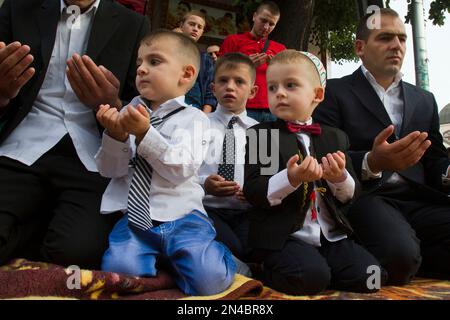 Kosovo Muslims offer Eid al-Fitr prayers outside the Sultan Mehmet Fatih grand mosque during the ...