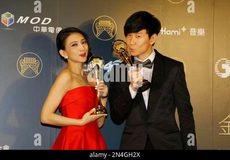 Malaysian singer Penny Tai, left and Singapore singer JJ Lin pose with ...