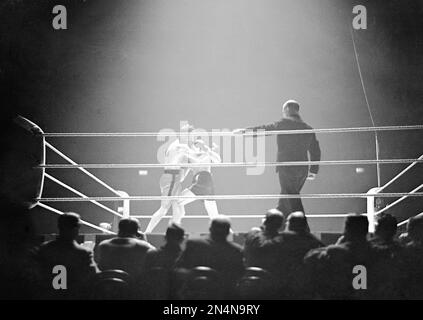 Champion Len Harvey of England, left, holds on to Jack Petersen of ...