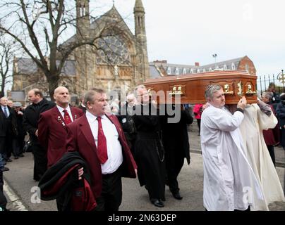 The coffin of Catholic Priest Alec Reid is driven along the Falls Road ...