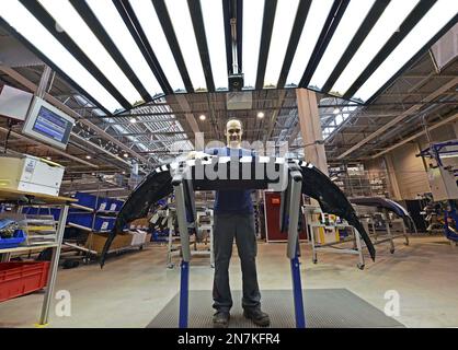 Assembler Christian Baumann transports a front car bumper during the ...