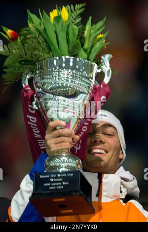 Netherlands’ Kjeld Nuis holds the trophy as he poses with Netherlands ...