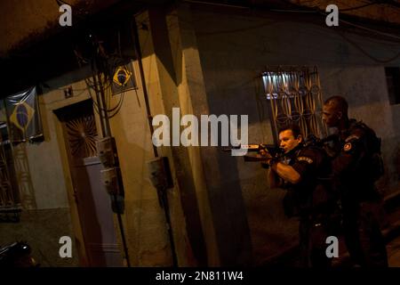 Police officers patrol the Parque Alegria slum during a conjoint ...