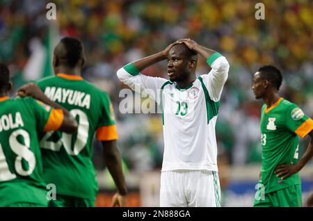Zambia goalkeeper Kennedy Mweene, center, leaps to catch a loose ball ...