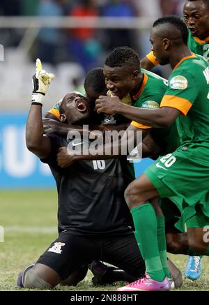 Zambia's goalkeeper Kennedy Mweene, left, dives to save a penalty kick ...