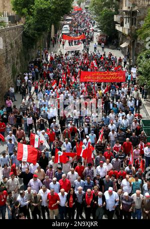 Supporters of the Lebanese Communist party, wave by Lebanese flags ...