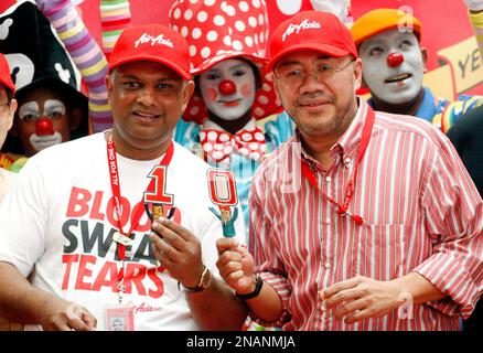AirAsia Chief Executive Tony Fernandes, left, poses with Tune Group ...