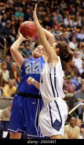 Duke's Tricia Liston, left, shoots as Presbyterian's Chelsea Parker (11 ...