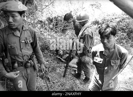Vietnamese soldiers capture a communist Viet Cong guerrilla hiding in ...