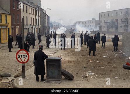 Riot police wearing helmets, carrying shields and supported by armored ...