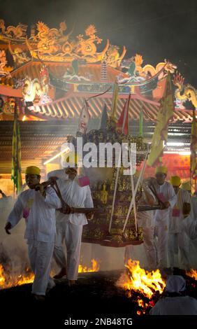 Malaysian Chinese carrying an Emperor God leaving a temple during a ...