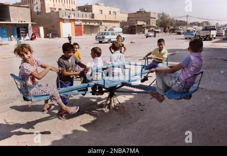 Iraqi children play during an Eid holiday celebration in Basra ...