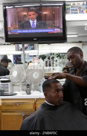 Marine Staff Sargent Brandon Foote, left, gets his hair cut by Darrell ...