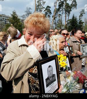 Widows of Chernobyl victims hold portraits of their husbands who died ...