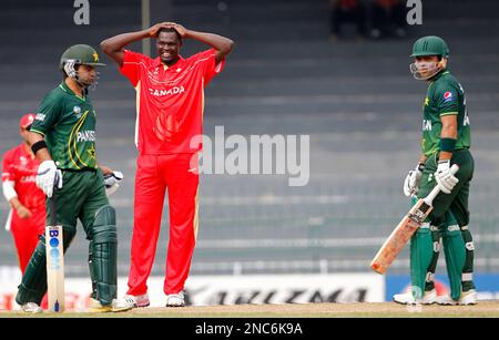 Canada's bowler Henry Osinde, center, celebrates with teammates Rizwan ...