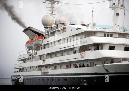 Greek-owned cruise ship 'Clelia II' is towed to the port of the town of ...
