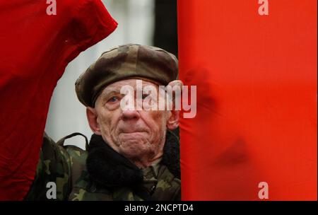 A member of the Belarusian Communist party holding a portraits of Josef ...