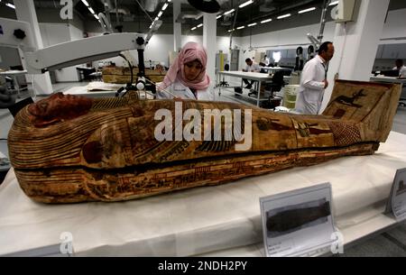 An Egyptian archeological technician works at a pharonic falcon mummy ...