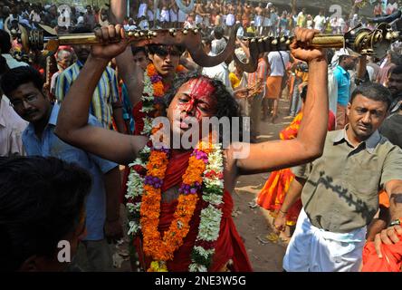 A Hindu devotee bleeds from his forehead in a ritual, in which devotees ...