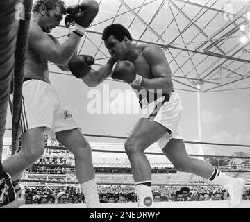 A left swing by Muhammad Ali glances off the face of Bob Foster in ...