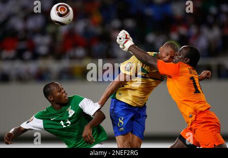 Zambia goalkeeper Kennedy Mweene, center, leaps to catch a loose ball ...