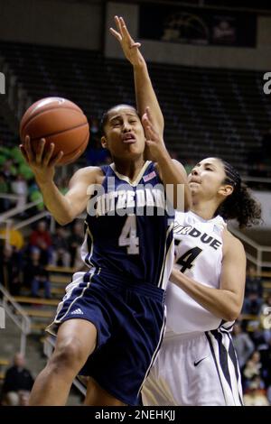 Notre Dame's Skylar Diggins, left, passes the ball over Texas A&M's Adrienne Pratcher in the ...
