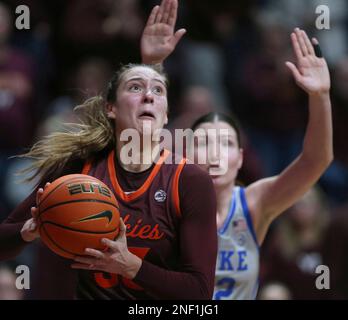 Virginia Tech's Elizabeth Kitley (33) shoots over Miami defenders ...