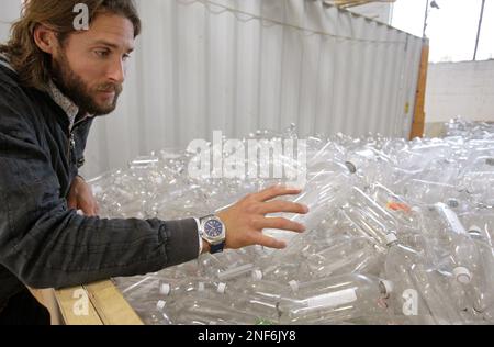 British environmentalist David de Rothschild stands beside a one third ...
