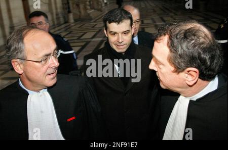 French judge Fabrice Burgaud, center, flanked by his lawyers Patrick ...