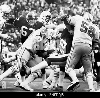 Houston Oilers Earl Campbell (34) looks for running room after taking a ...