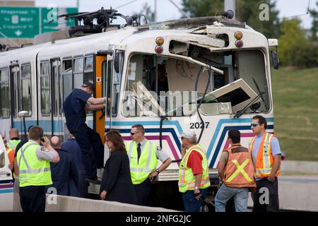 Police and transit workers investigate the scene of a Light Rapid ...