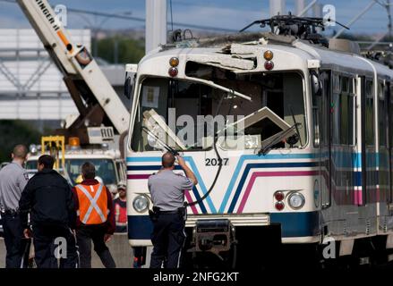 Police and transit workers investigate the scene of a Light Rapid ...
